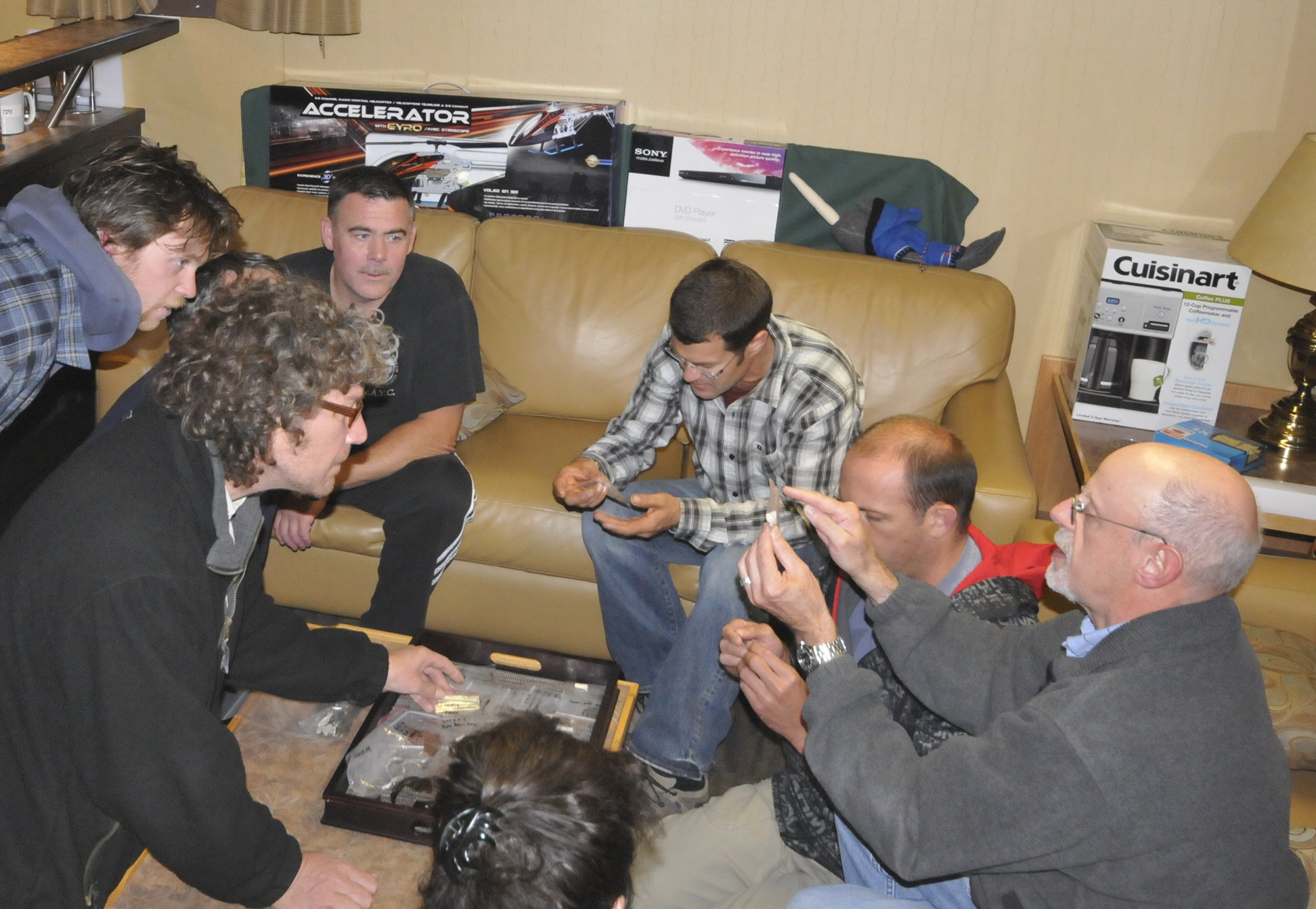 Doug Stenton Shows Artefacts Collected at Cape Felix Site to Crew Members